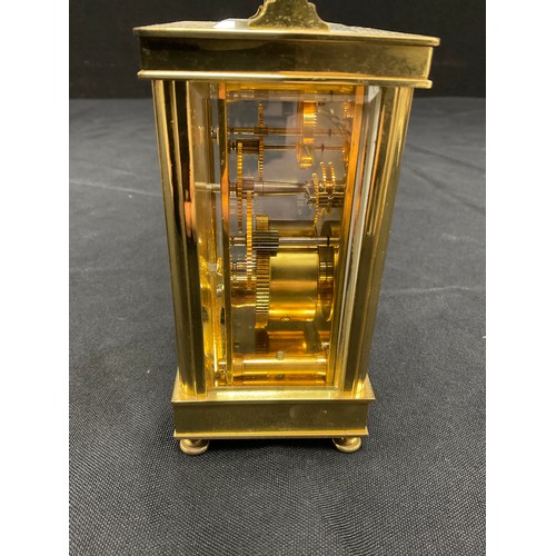 A lacquered brass carriage timepiece, enamel clock dial inscribed ...