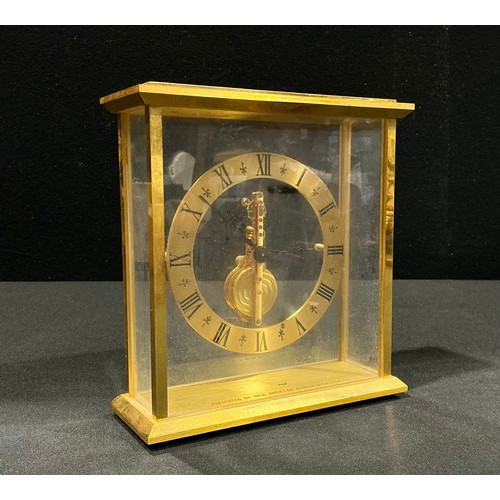 A Jaeger Le-Coultre gilt brass skeleton clock, the case applied with ...