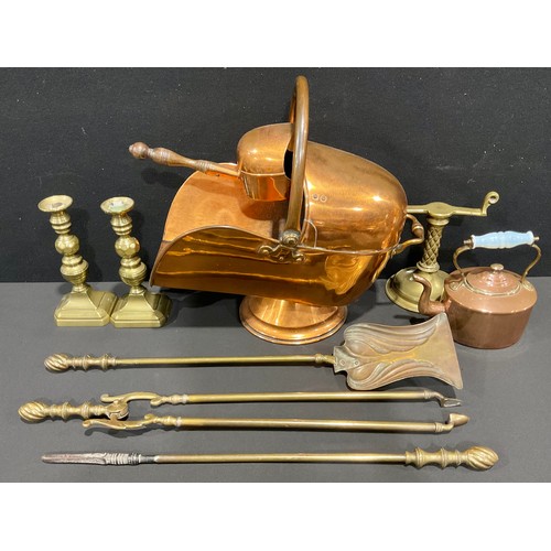 An Art Nouveau brass three-piece fireside companion set, c.1900; a ...