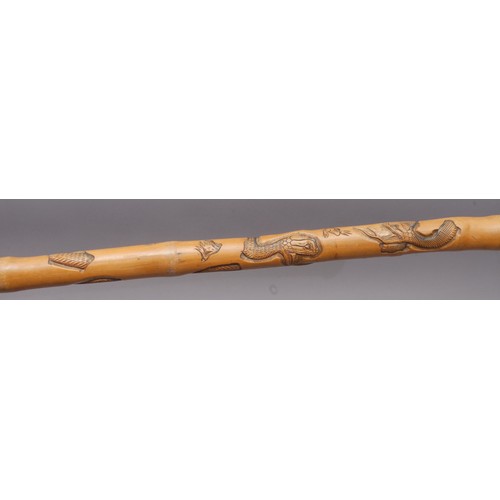 A Japanese bamboo walking stick, the cane carved with snakes, 87cm long ...