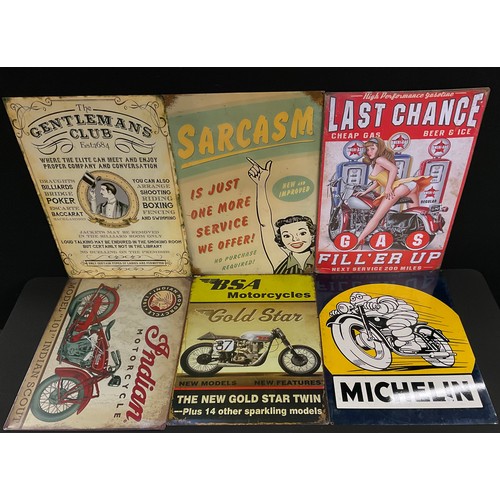 A collection of reproduction advertising signs, including BSA ...