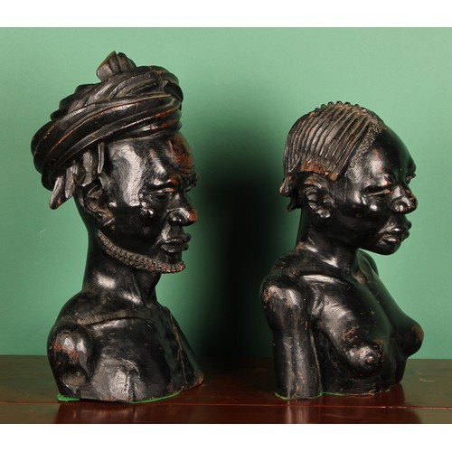 A pair of ebonised portrait busts, carved as Nubian male and female ...