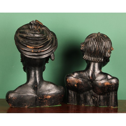 A pair of ebonised portrait busts, carved as Nubian male and female ...
