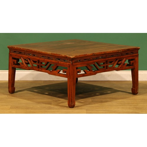 A Chinese hardwood low tea table, square top, the apron with angular ...