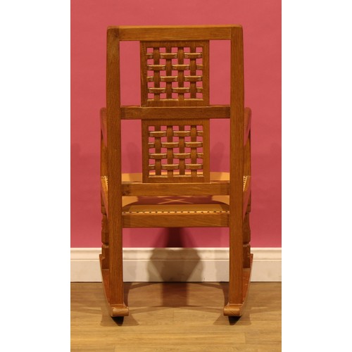 Robert Thompson, Mouseman of Kilburn - an oak rocking chair, carved ...