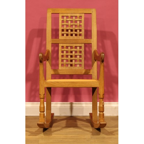 Robert Thompson, Mouseman of Kilburn - an oak rocking chair, carved ...