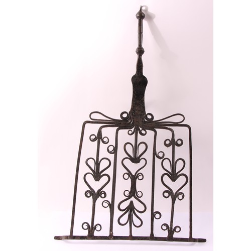 An Arts & Crafts wrought iron trivet, the rectangular plateau worked ...