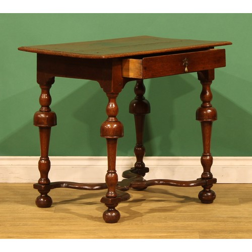 An 18th century oak side table, oversailing rectangular top above a ...