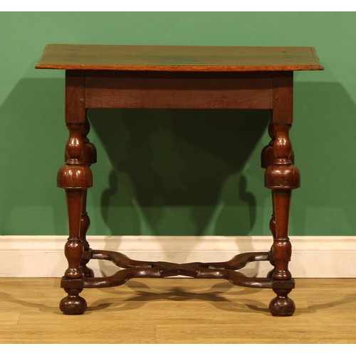 An 18th century oak side table, oversailing rectangular top above a ...