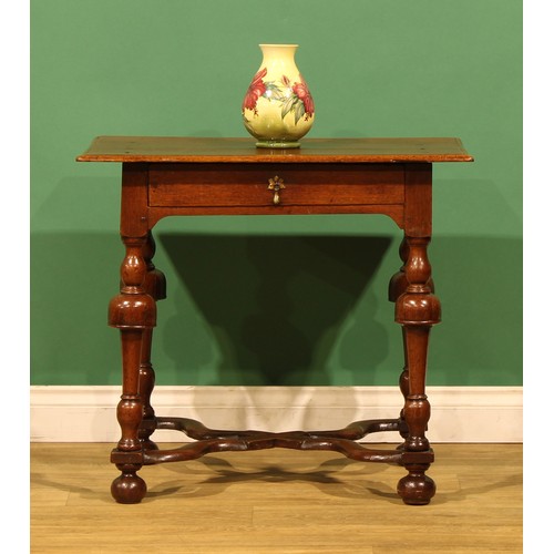An 18th century oak side table, oversailing rectangular top above a ...