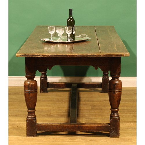 A 17th century style oak refectory type dining table, plank top with ...