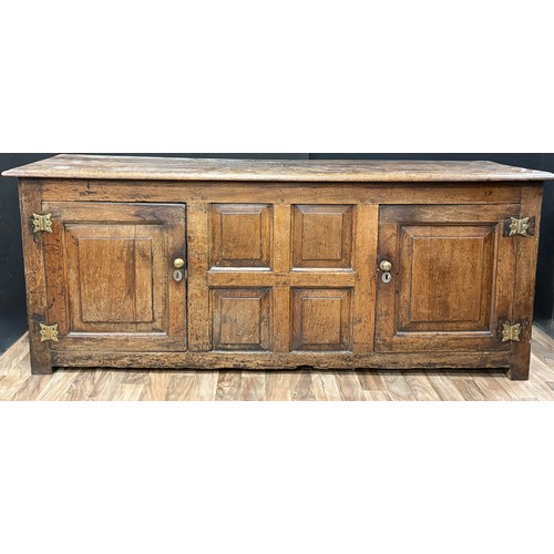 An '18th century' oak low dresser or side cabinet, oversailing top ...