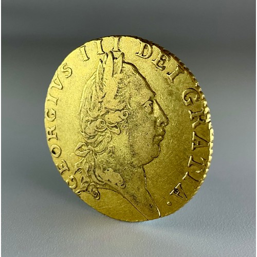 A 1790 George III gold guinea coin, on the obverse a laureate portrait ...