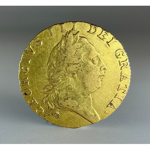 A 1790 George III gold guinea coin, on the obverse a laureate portrait ...