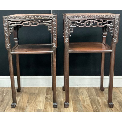 A pair of Chinese hardwood side tables, the rectangular top inset with ...