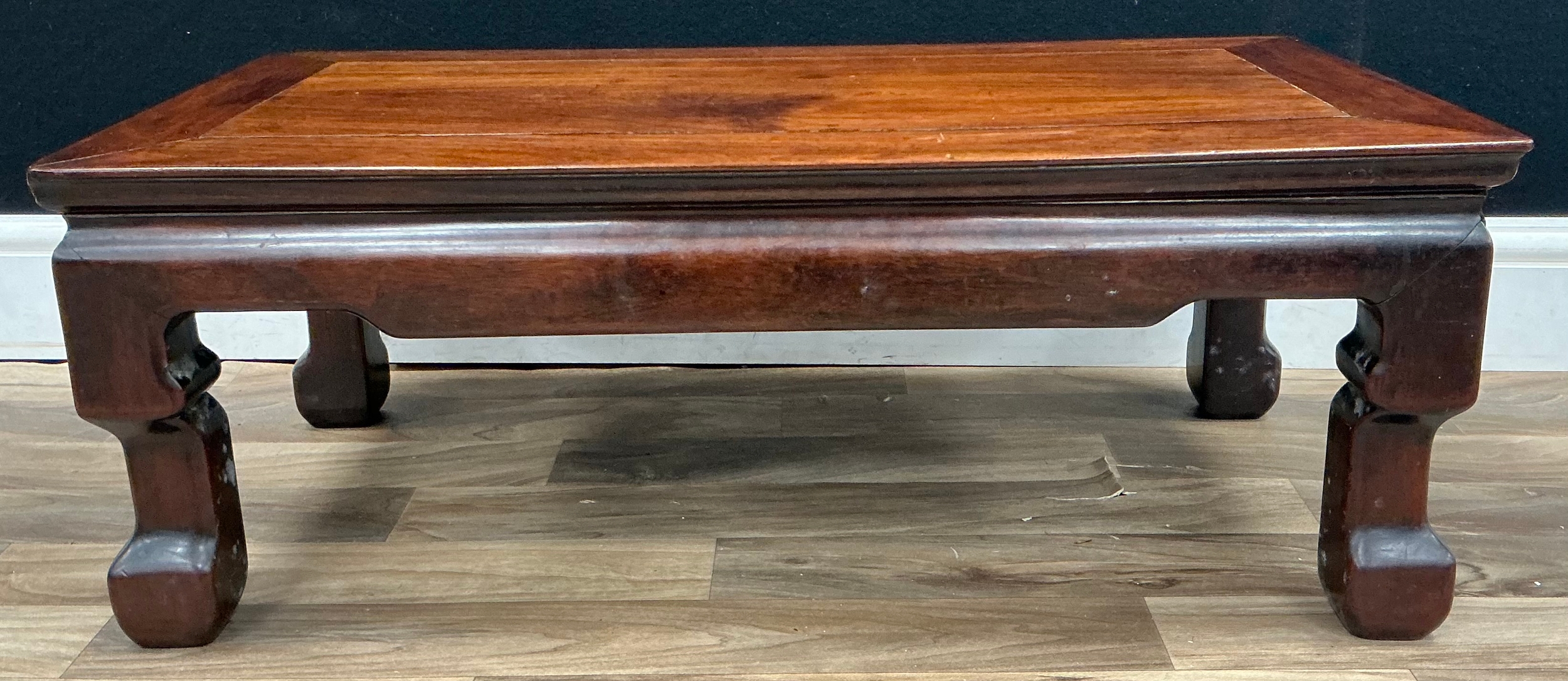 A Chinese hardwood low tea table, rectangular top with a finely moulded ...