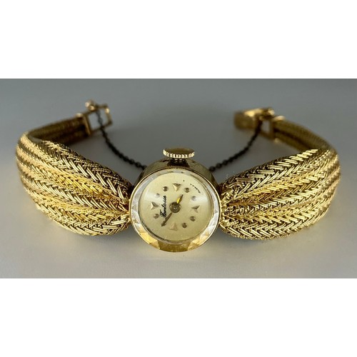 Eloga - a ladies gold metal cased bracelet wristwatch, textured ...