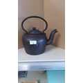 Antique cast iron kettle with rounded handle and spout, likely from the ...