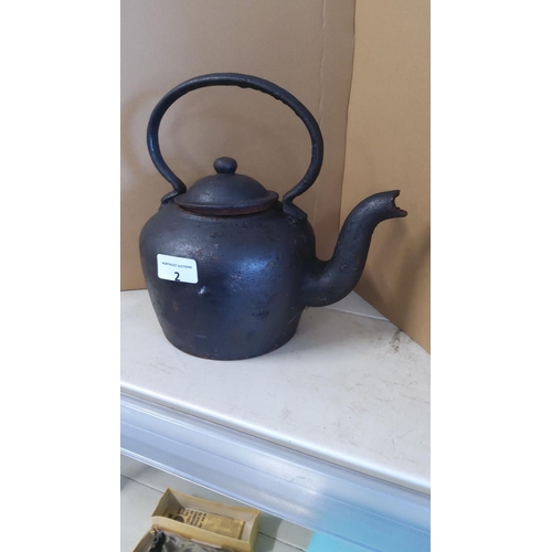 Antique cast iron kettle with rounded handle and spout, likely from the ...