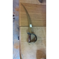 Antique cutlass with brass hilt and wooden handle, featuring a curved ...