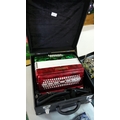 Red pearloid Baronelli piano accordion with green treble grille ...