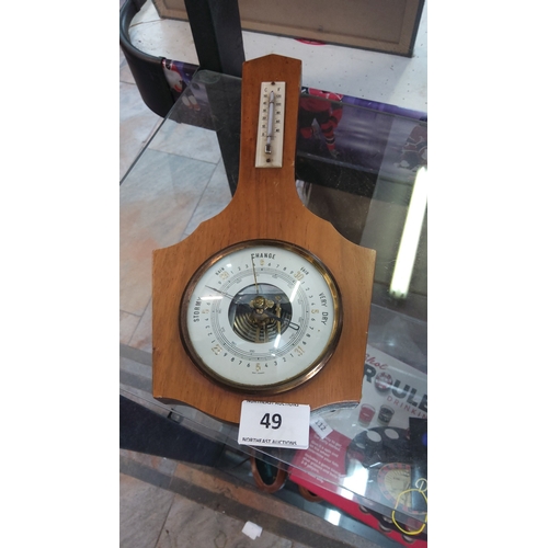 Mid-century wall-mounted aneroid barometer with central visible ...