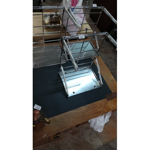 Pair of chrome-plated steel wire frames with drilled sheet-metal bases ...