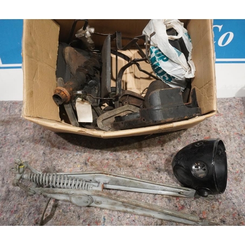Box of motorcycle parts including girder fork, headlamp case, seat etc