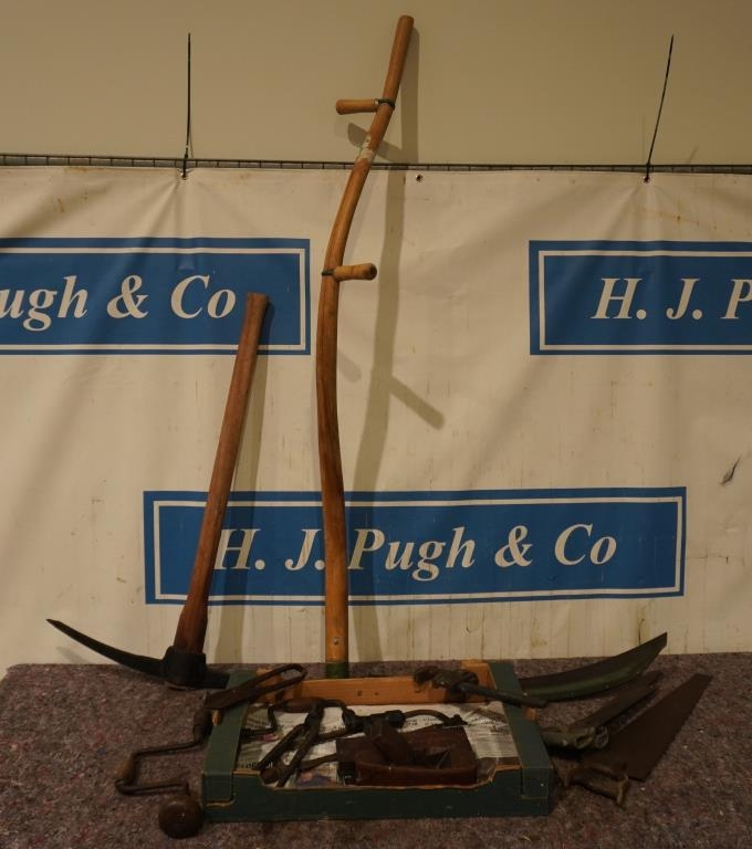 Scythe, pick axe and assorted old hand tools