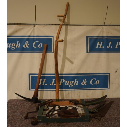Scythe, pick axe and assorted old hand tools
