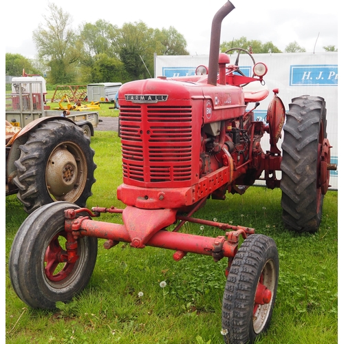 Farmall model BM tractor with wheel weights. Starts and drives. Serial ...