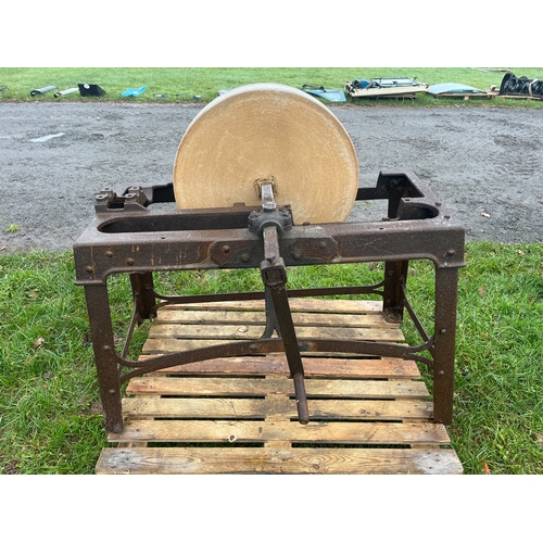 Large grindstone on cast iron base