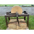 Large grindstone on cast iron base