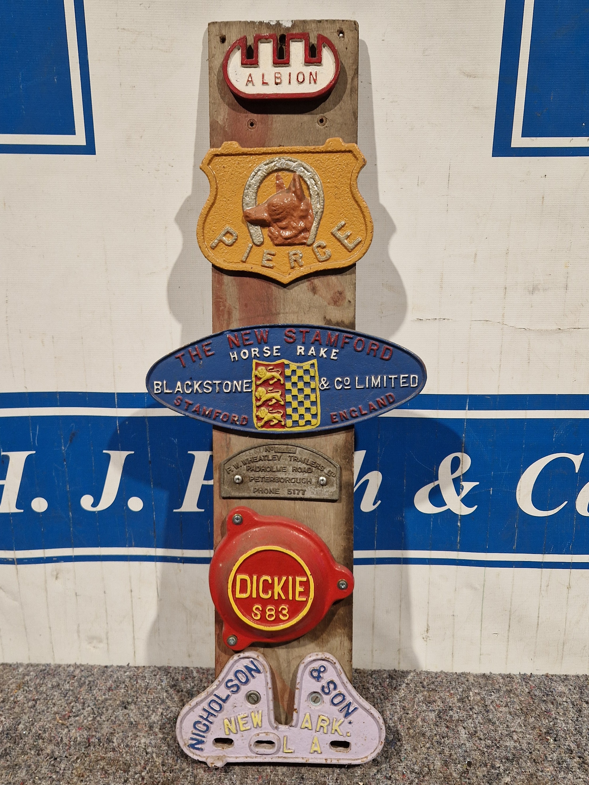 Display board of cast iron name plates to include Dickie, Pierce ...