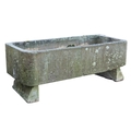 Large antique weathered carved natural stone trough raised on a pair of ...