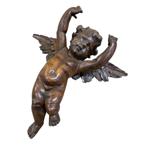 An 18th / 19th century carved oak winged cherub, H 31cm x W 37cm