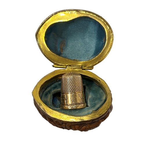 A 19th century walnut thimble case and a gold thimble, the thimble ...