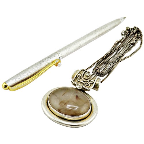 A rutilated quartz oval 'bulla' shaped pendant; a Mikimoto ballpoint ...