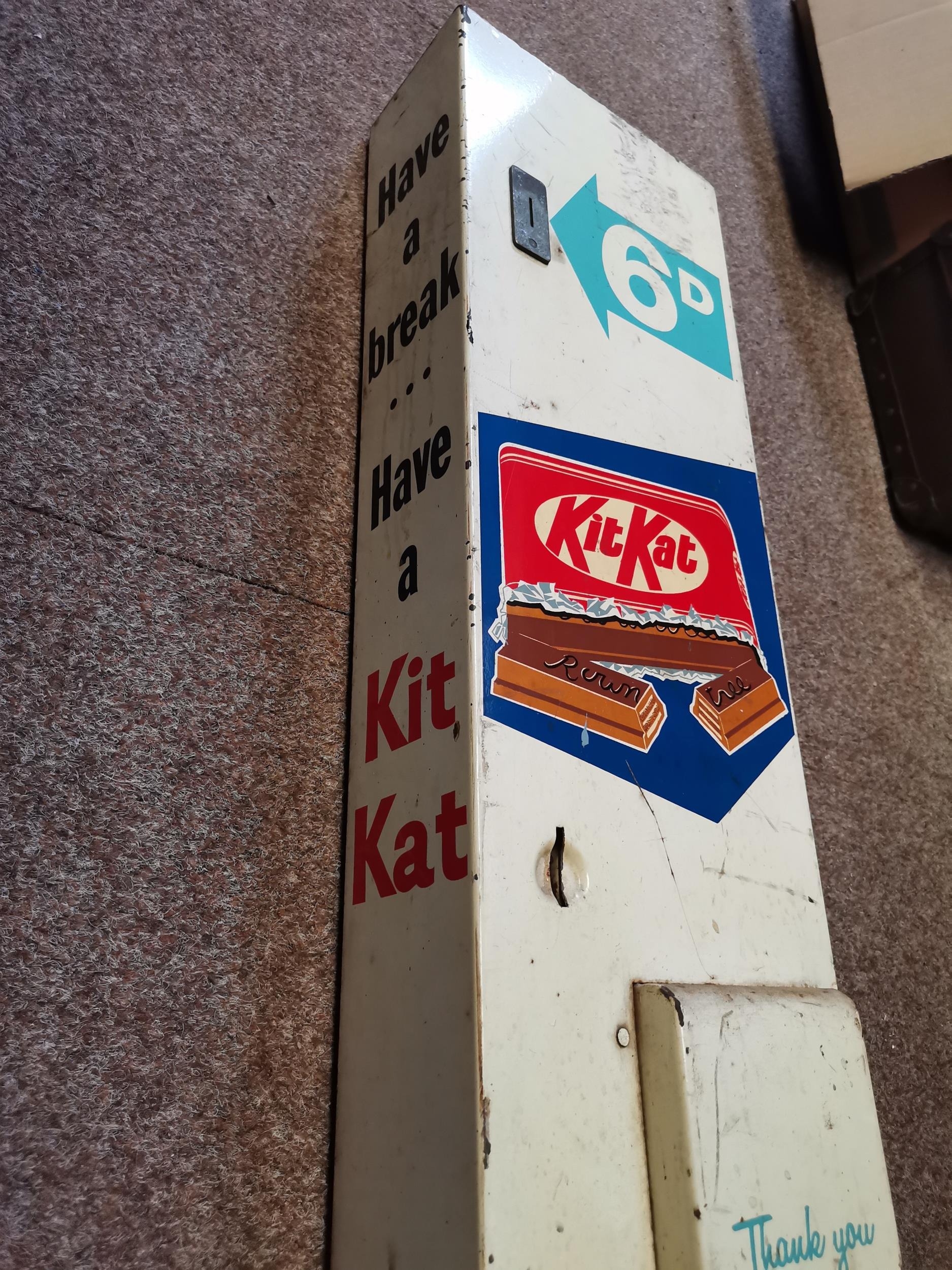 A vintage Kit Kat 6d vending machine, white with coloured decals. 81 ...