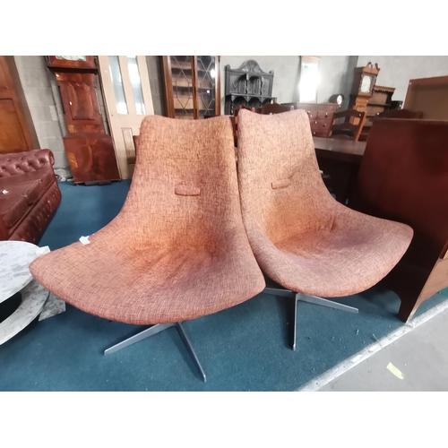 A pair of Scandinavian (Lurashell) swivel chairs in a burnt orange ...