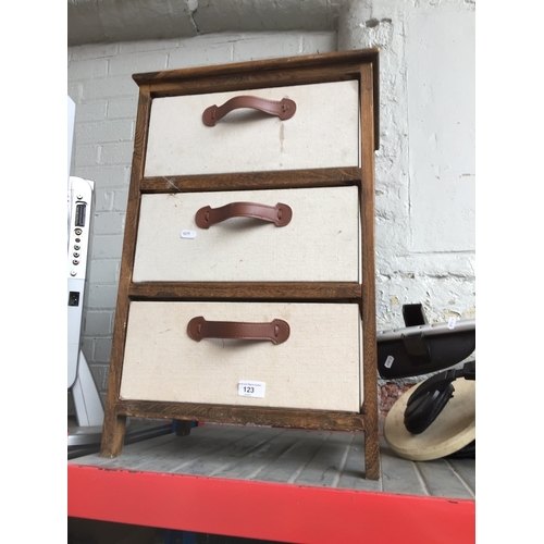A wooden unit with 3 canvas drawers.