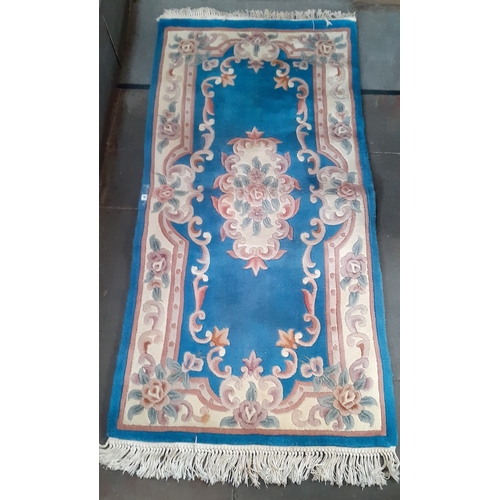 An oriental Kayam wool carpet, blue ground decorated with flowers ...