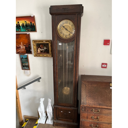 An early 20th century oak longcase clock with brass dial.