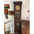 An early 20th century oak longcase clock with brass dial.