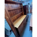 An early 20th century utilitarian beech dresser with plate rack back.