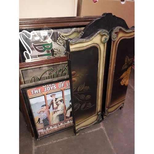 A collection of advertising mirrors, pictures and prints.