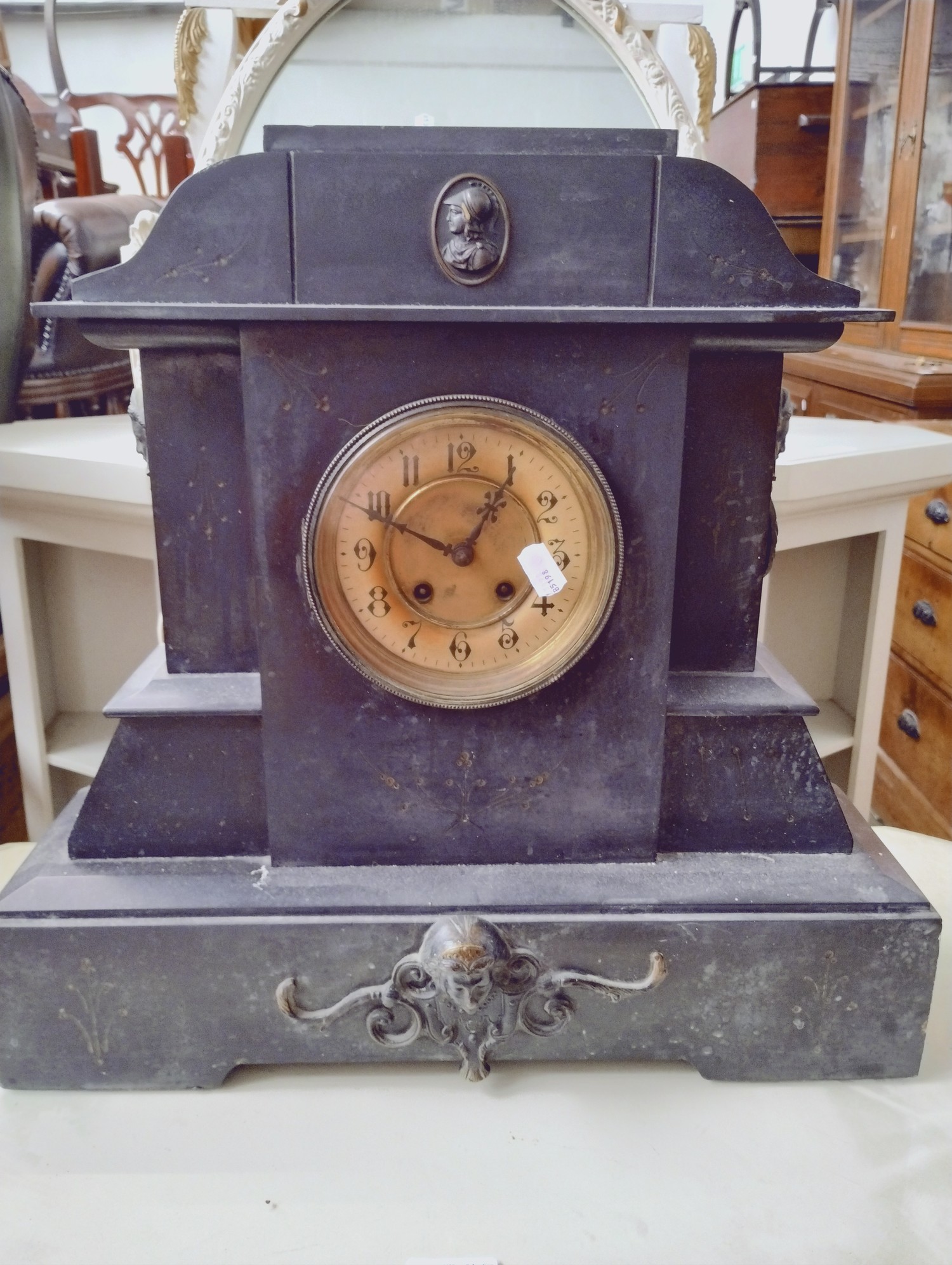 A Victorian black slate mantle clock.