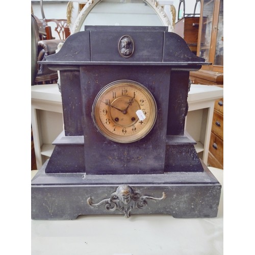 A Victorian black slate mantle clock.