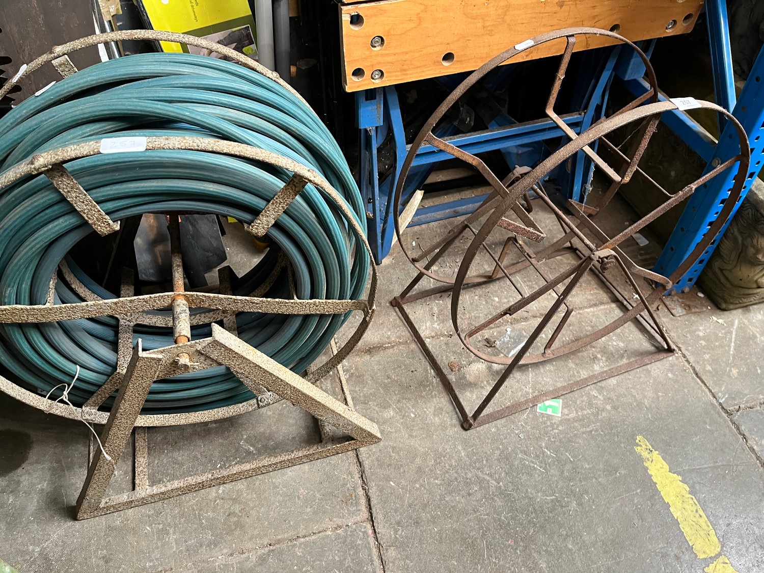 2 metal hose pipe reels, including one with plastic hose