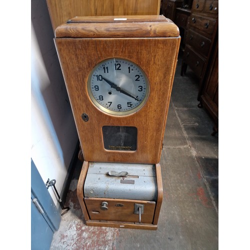 An early 20th century oak cased 'Synchromatic Time System' clocking in ...